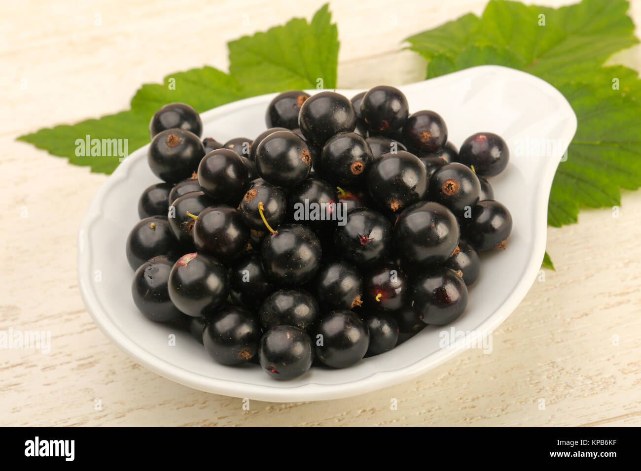 Ripe black currants in the bowl with leaf Stock Photo - Alamy