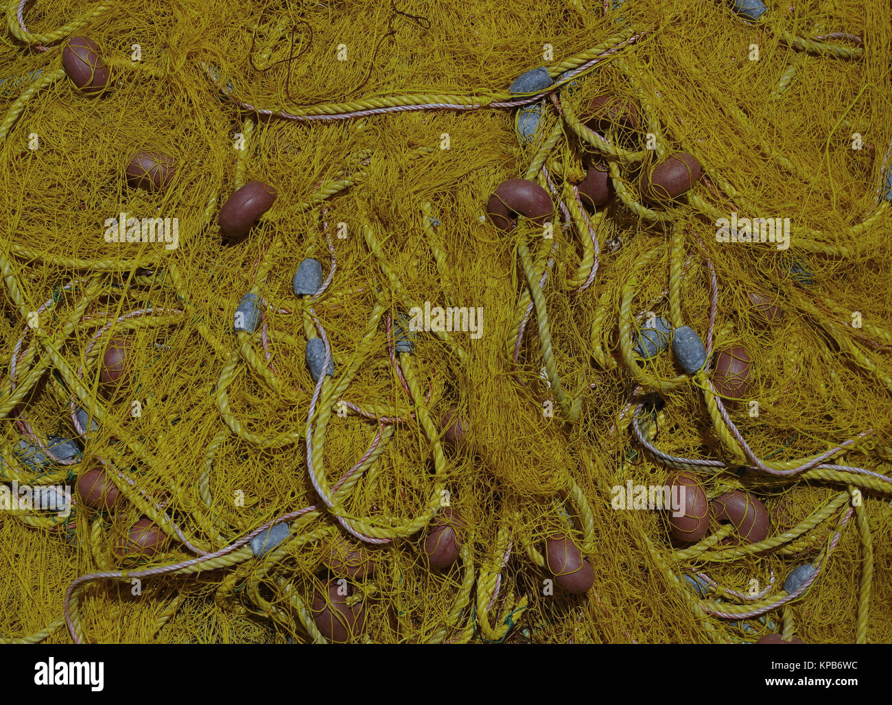 Bright yellow fishing net in a greek harbor Stock Photo - Alamy