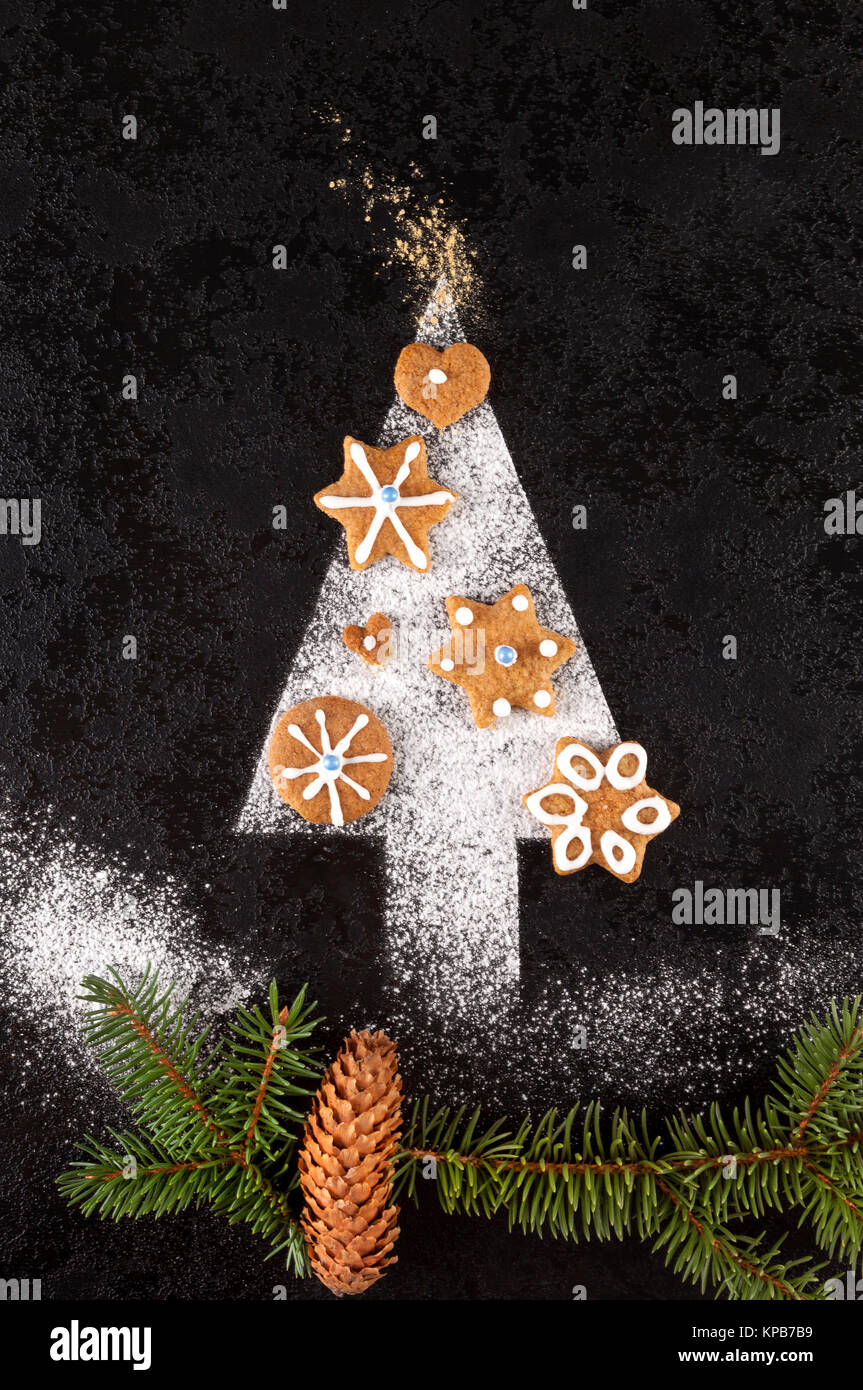 Powdered Sugar Christmas tree with gingerbread and pine twig and cone ...