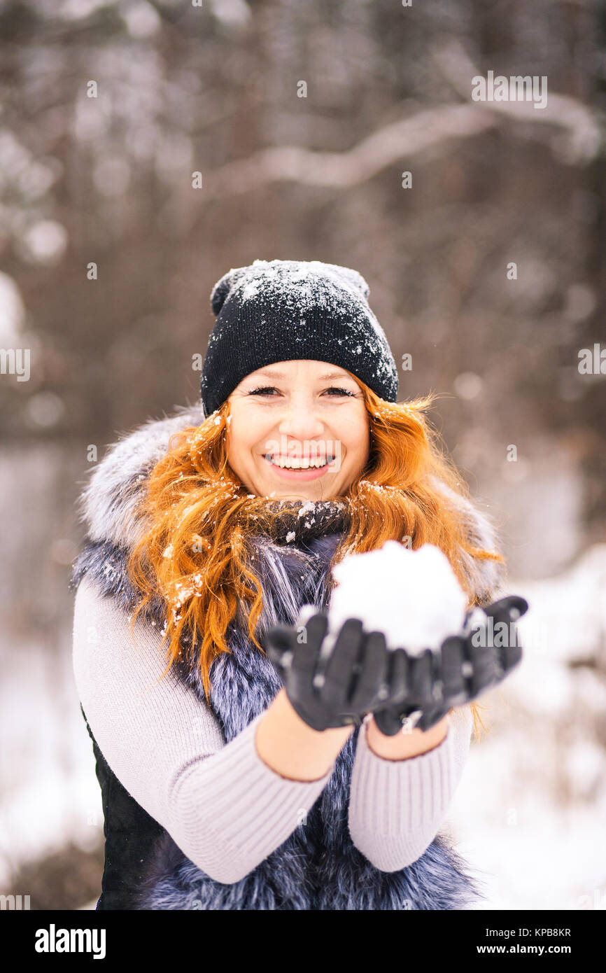 Winter beautiful girl outdoor portrait with snow in hands. Young woman ...