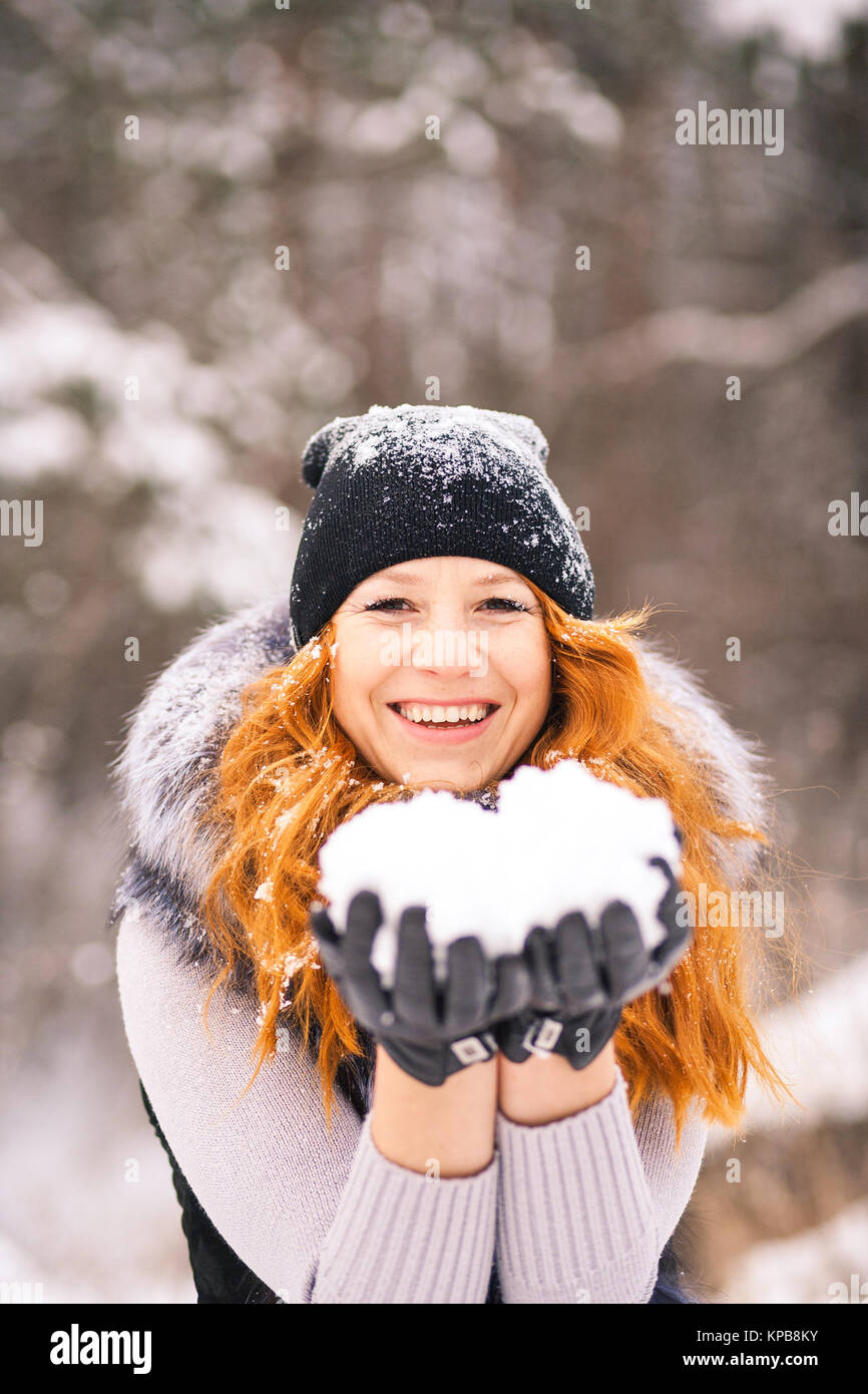 Winter beautiful girl outdoor portrait with snow in hands. Young woman ...