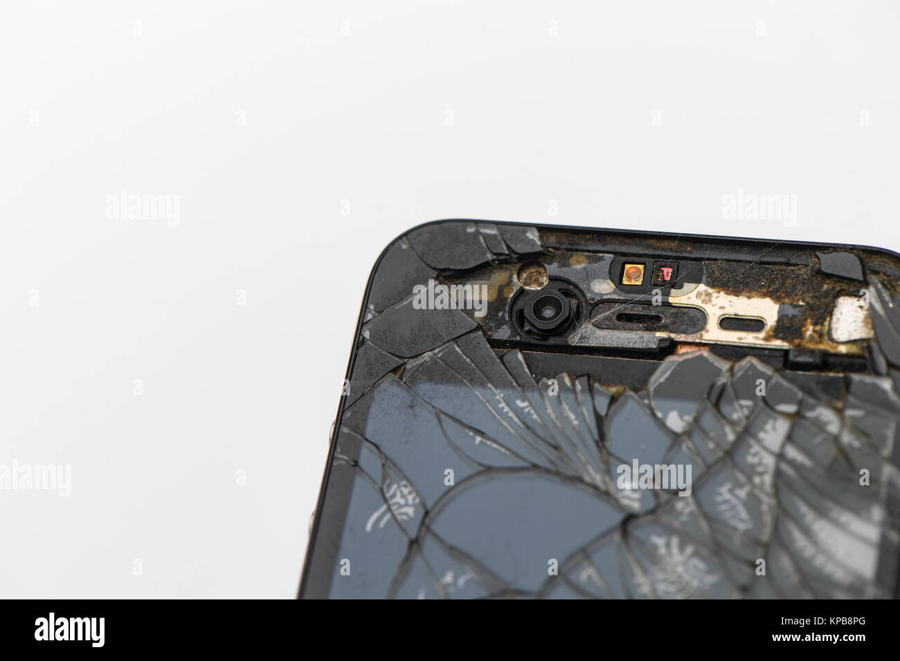A badly cracked second generation iPhone on a white background Stock ...