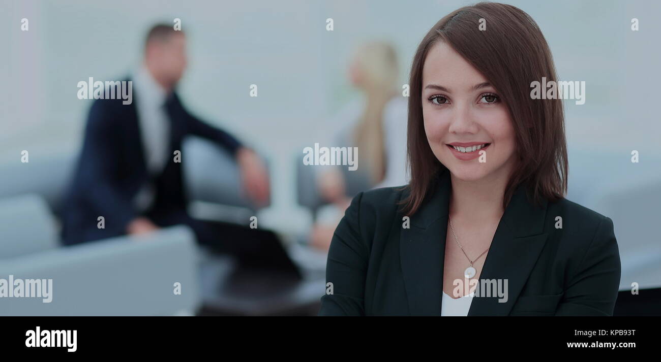 Successful business woman standing with her staff in background Stock ...