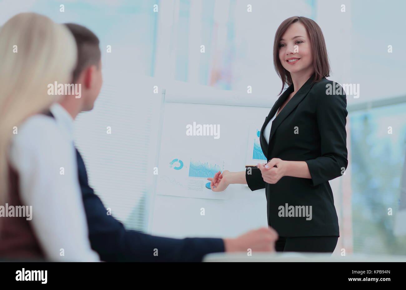 Businesswoman asking question during her colleagues presentation Stock ...