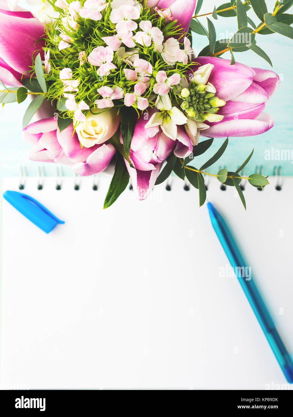 Blank empty notebook page with blue pen. Spring summer flat lay with ...