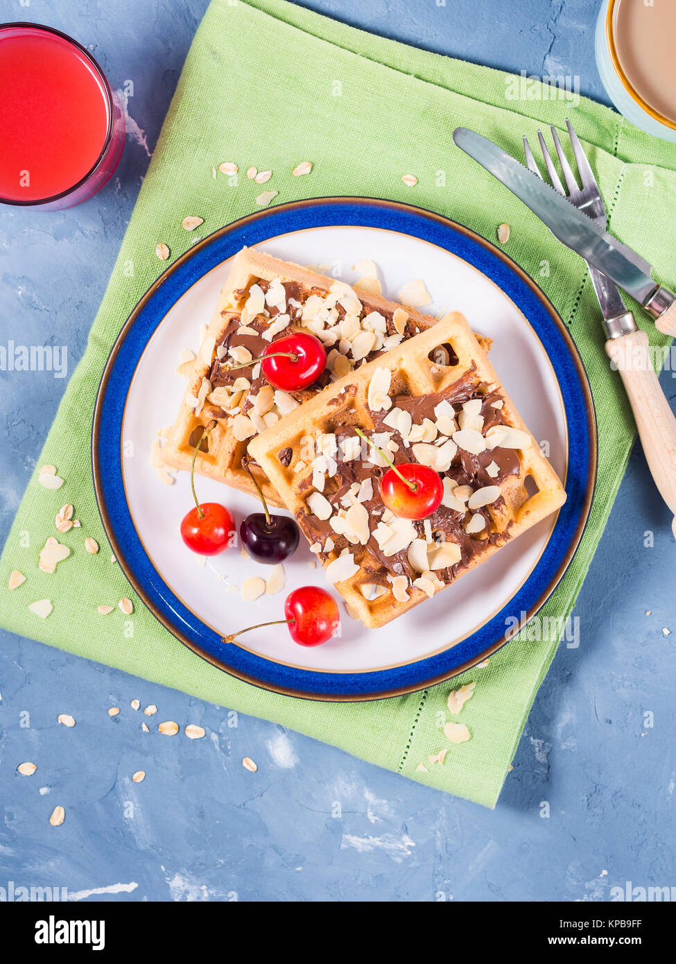 Sweet treat belgian waffles with chocolate almond shreds and cherries ...