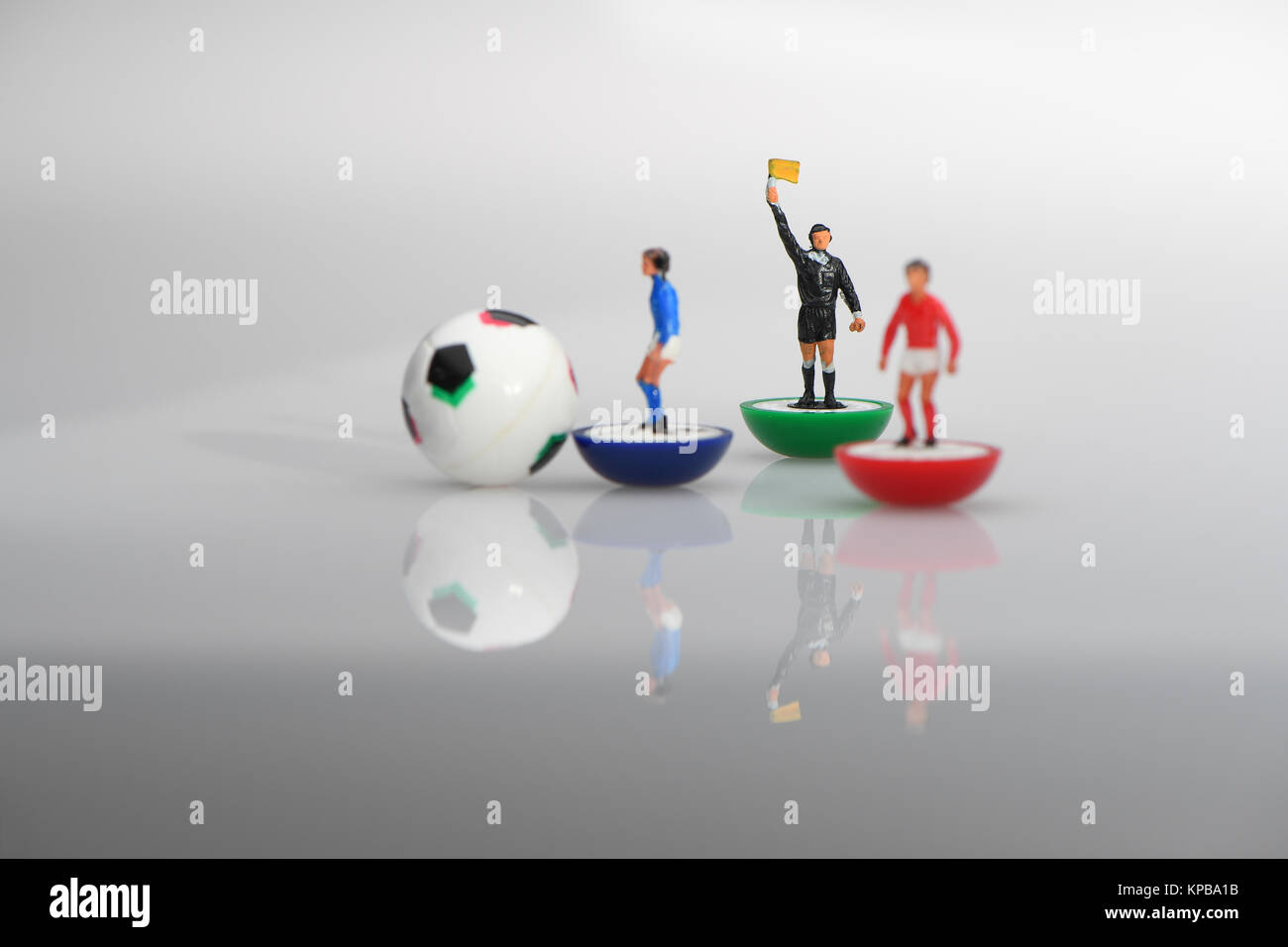 Offside rule shown with Subbuteo players and linesman Stock Photo - Alamy