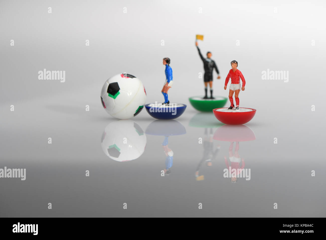 Offside rule shown with Subbuteo players and linesman Stock Photo - Alamy