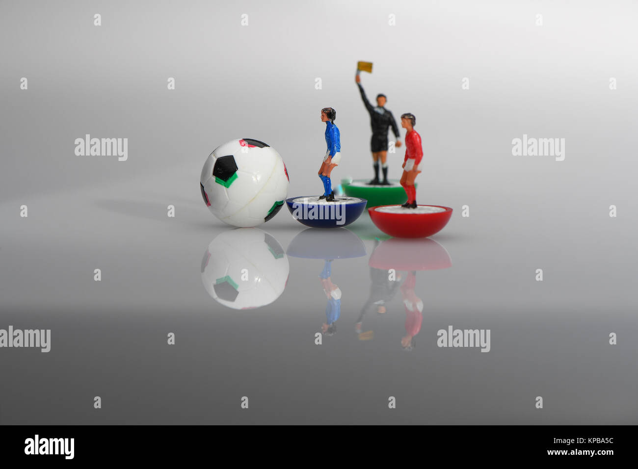 Offside rule shown with Subbuteo players and linesman Stock Photo - Alamy