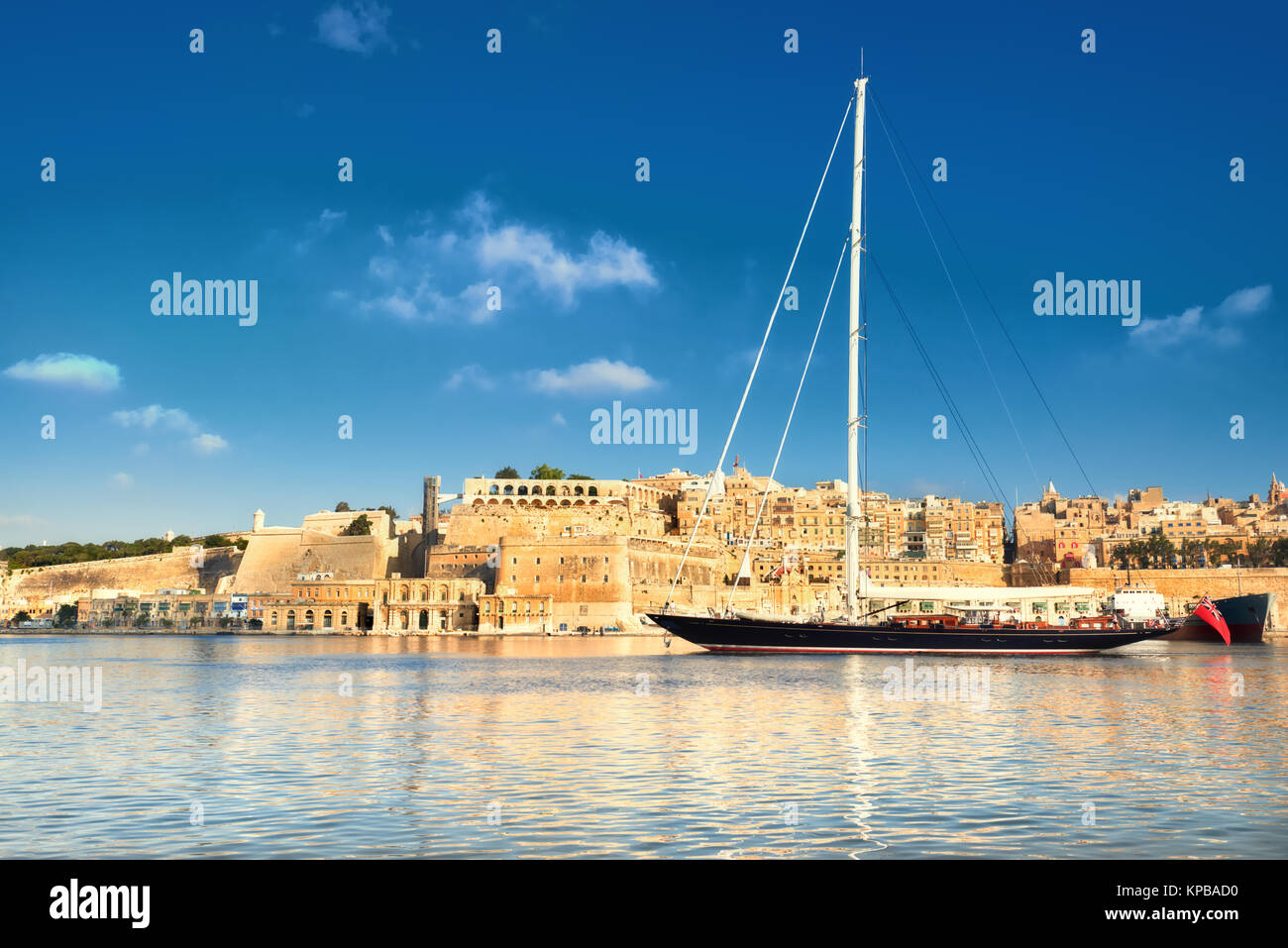 Sailing ship enters Grand Valetta bay with a view over Valetta's ...