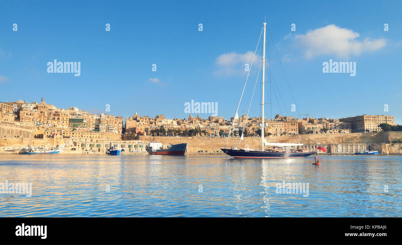 Sailing ship enters Grand Valetta bay with a view over Valetta's ...