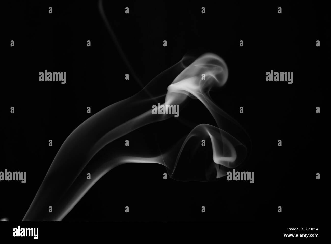 A whisp of white smoke against the black background Stock Photo - Alamy