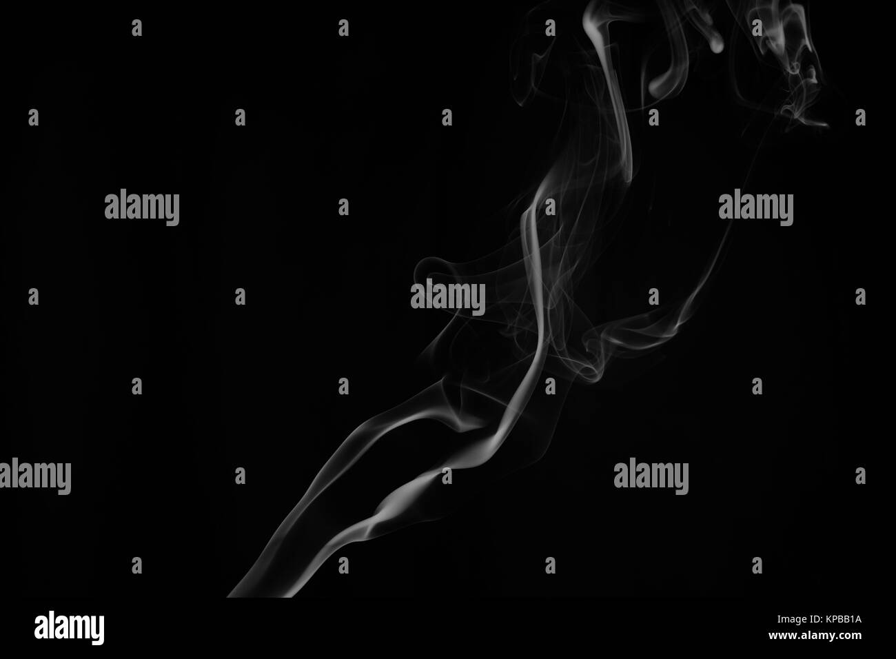 A whisp of white smoke against the black background Stock Photo - Alamy