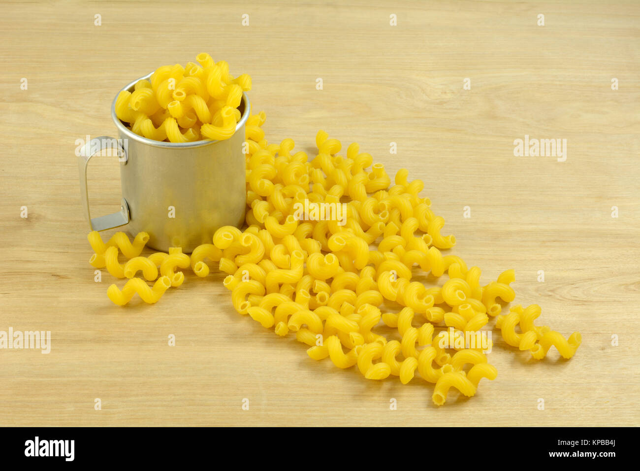 Raw dry cavatappi corkscrew pasta in and overflowing from antique ...