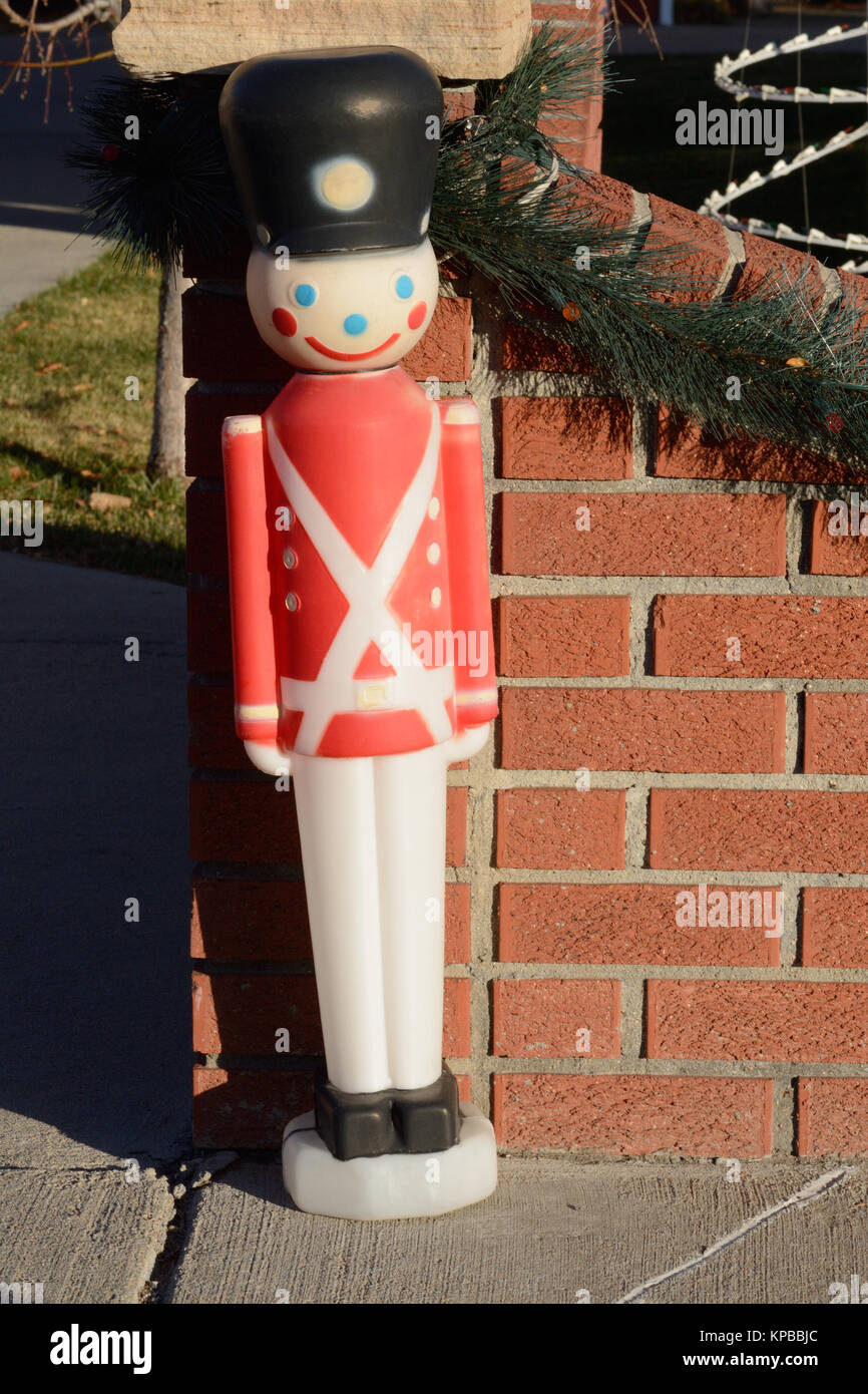Soldier guard Christmas lawn decoration propped against brick wall ...