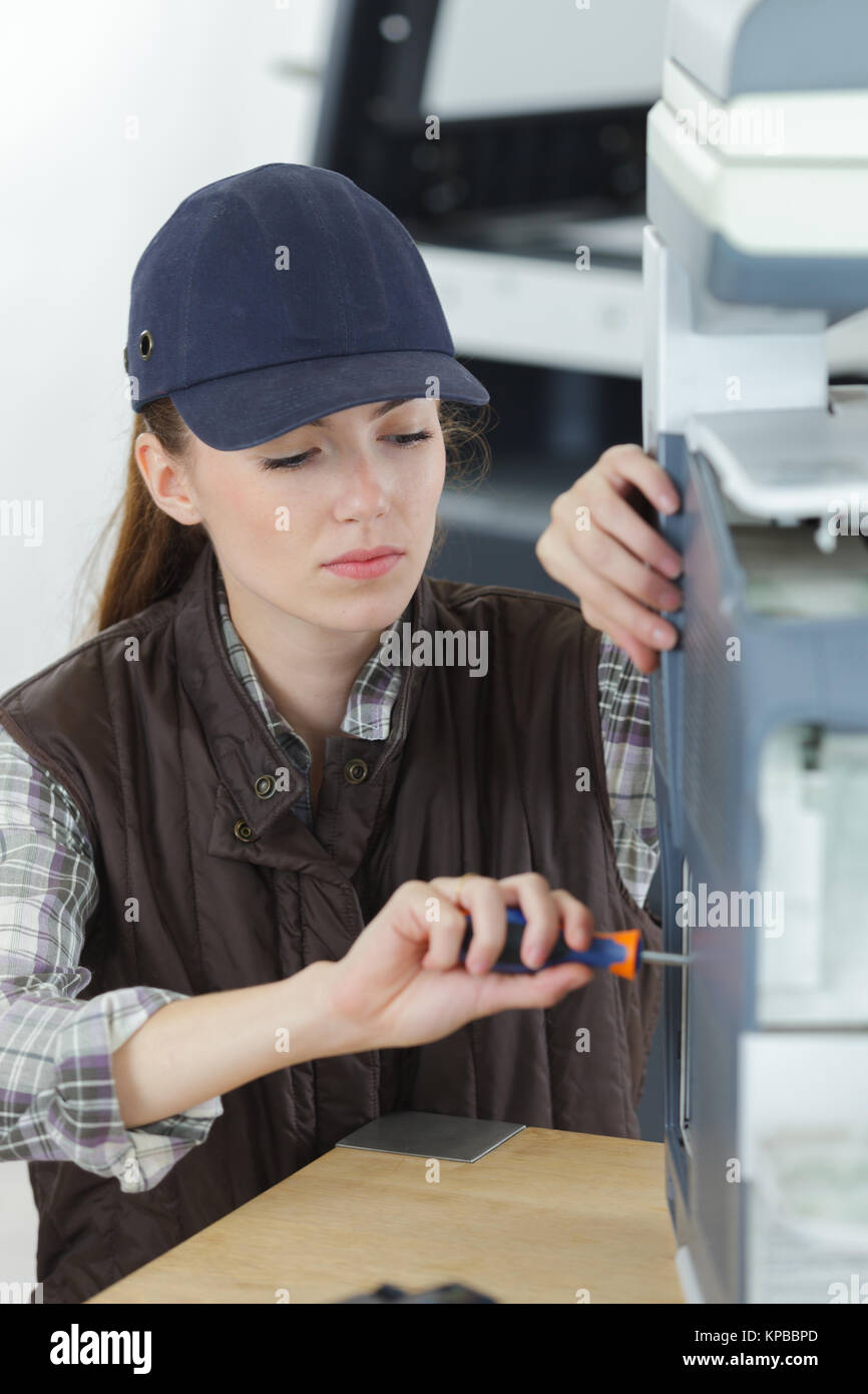 young woman doing printer maintenance Stock Photo - Alamy