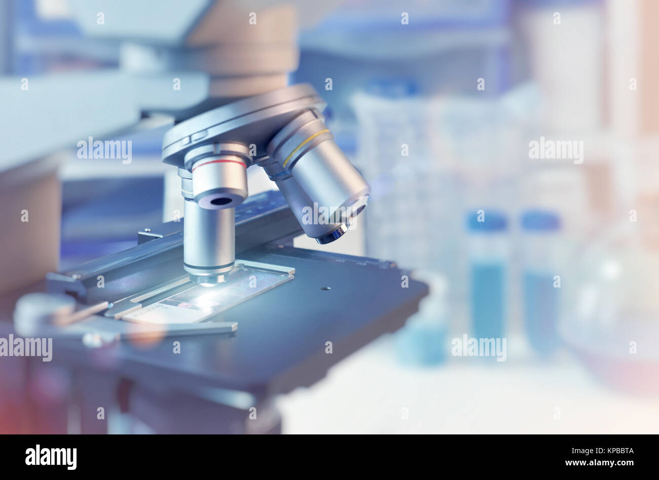 Scientific background with closeup on light microscope and laboratory ...