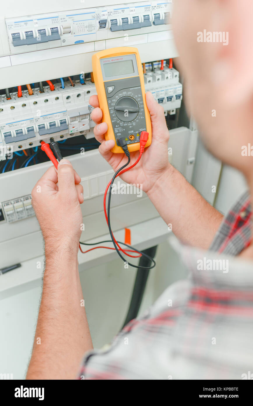 Electrician using a device Stock Photo - Alamy
