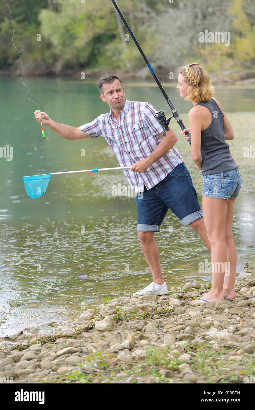 couple trying to catch fish Stock Photo - Alamy