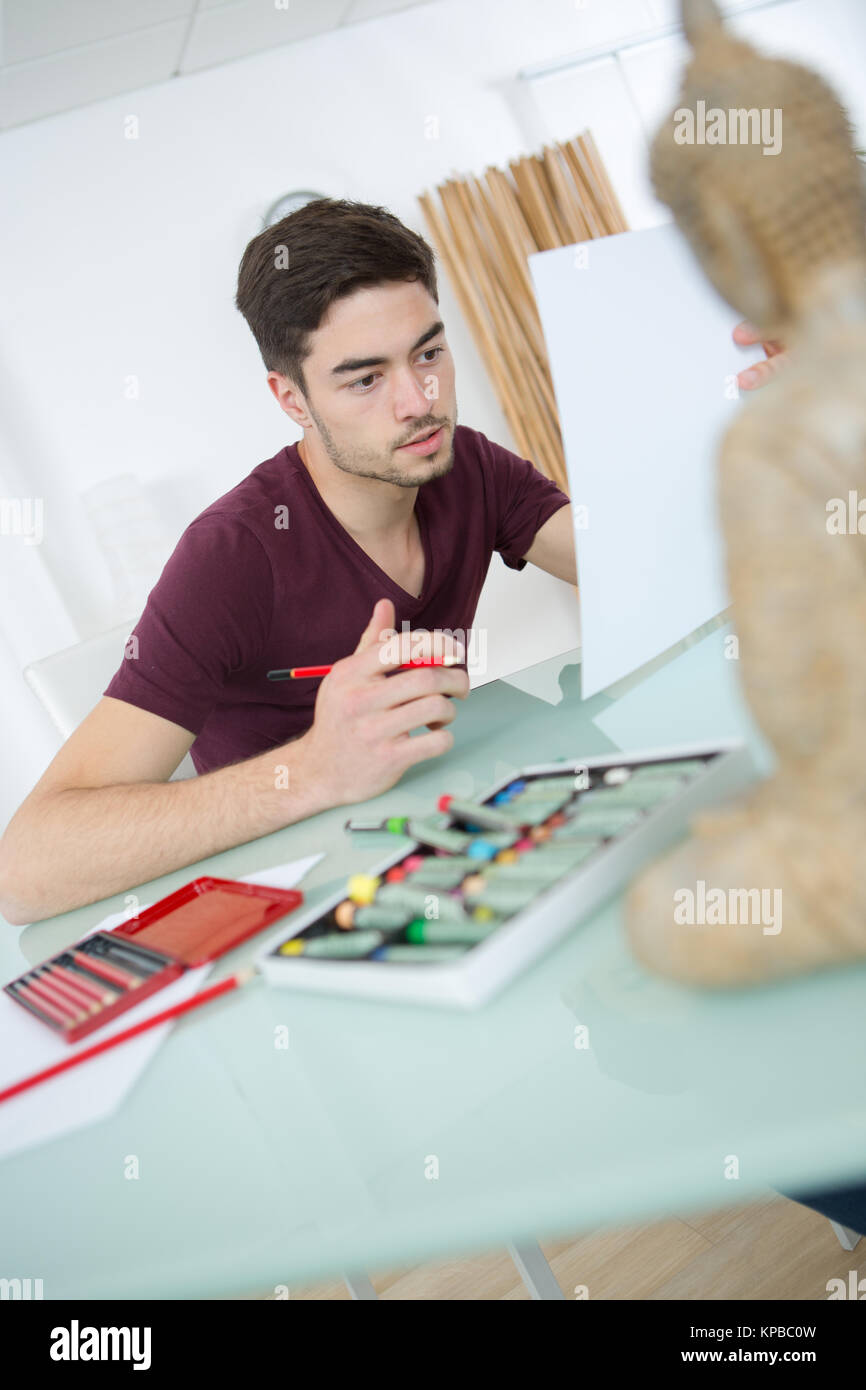 young man drawing pictures in studio Stock Photo - Alamy