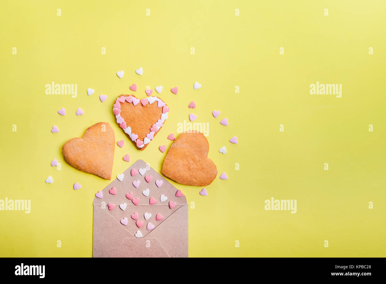 Open craft paper envelope with fly out sugar candies and heart shaped ...