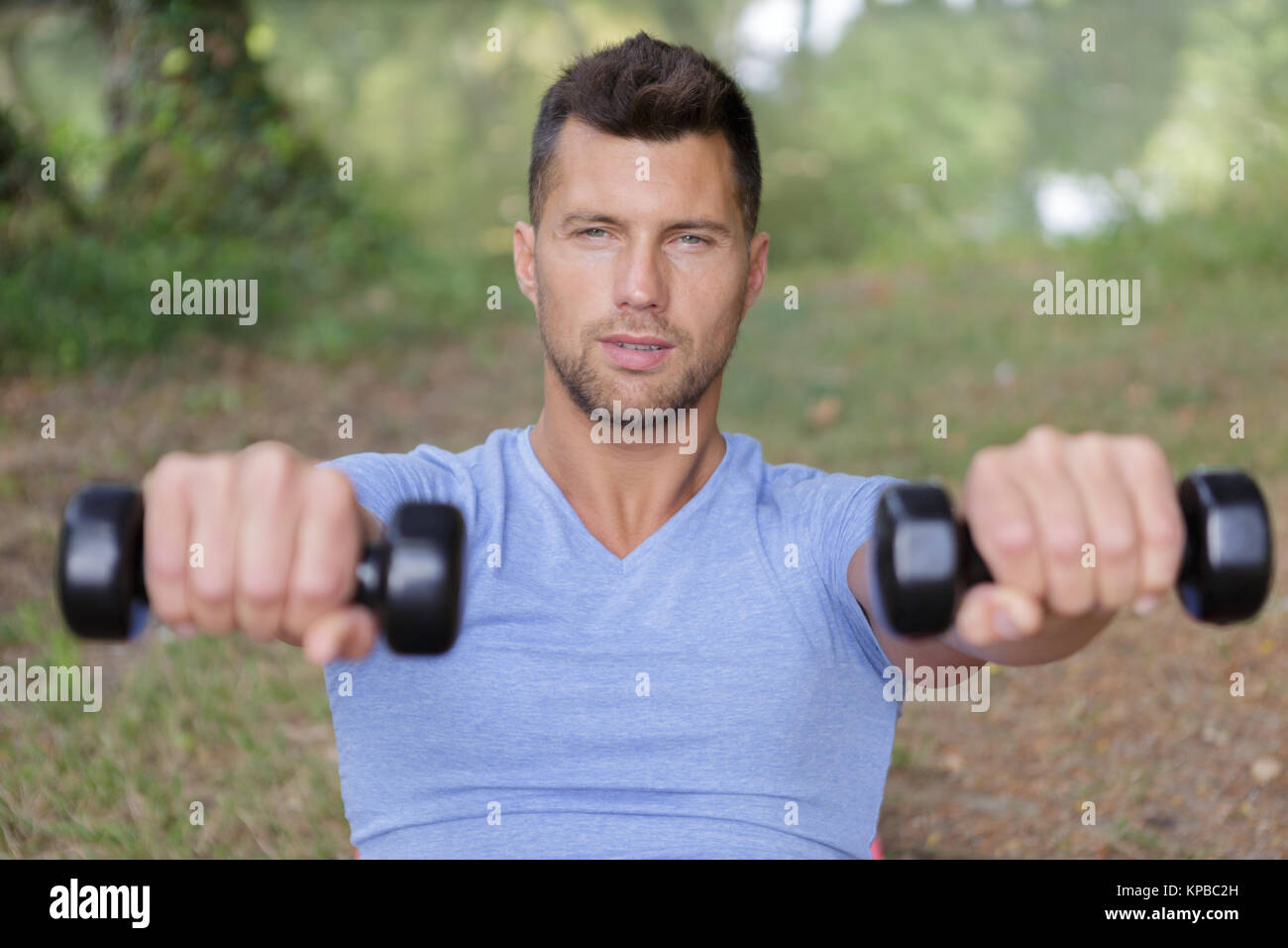 man lifting hand weights Stock Photo - Alamy