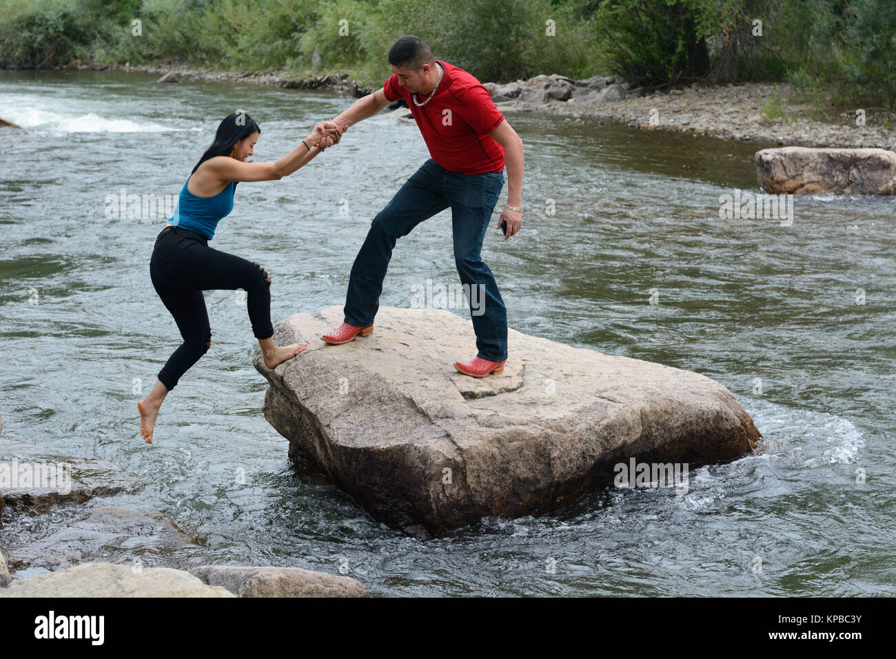 Rock jump holding hands hi-res stock photography and images - Alamy
