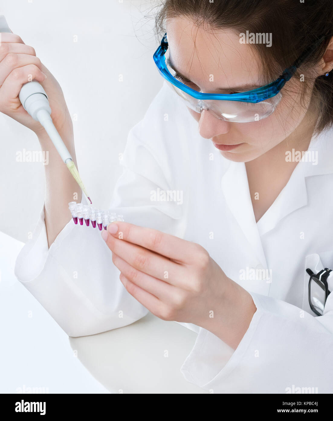 Young scientist holds stripe of samples for DNA amplification Stock ...