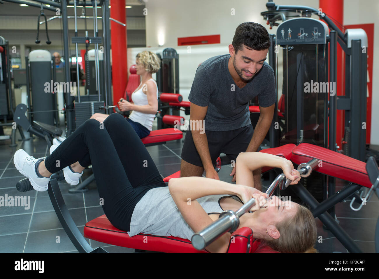 young smiling male coach assisting woman using fly machine Stock Photo ...