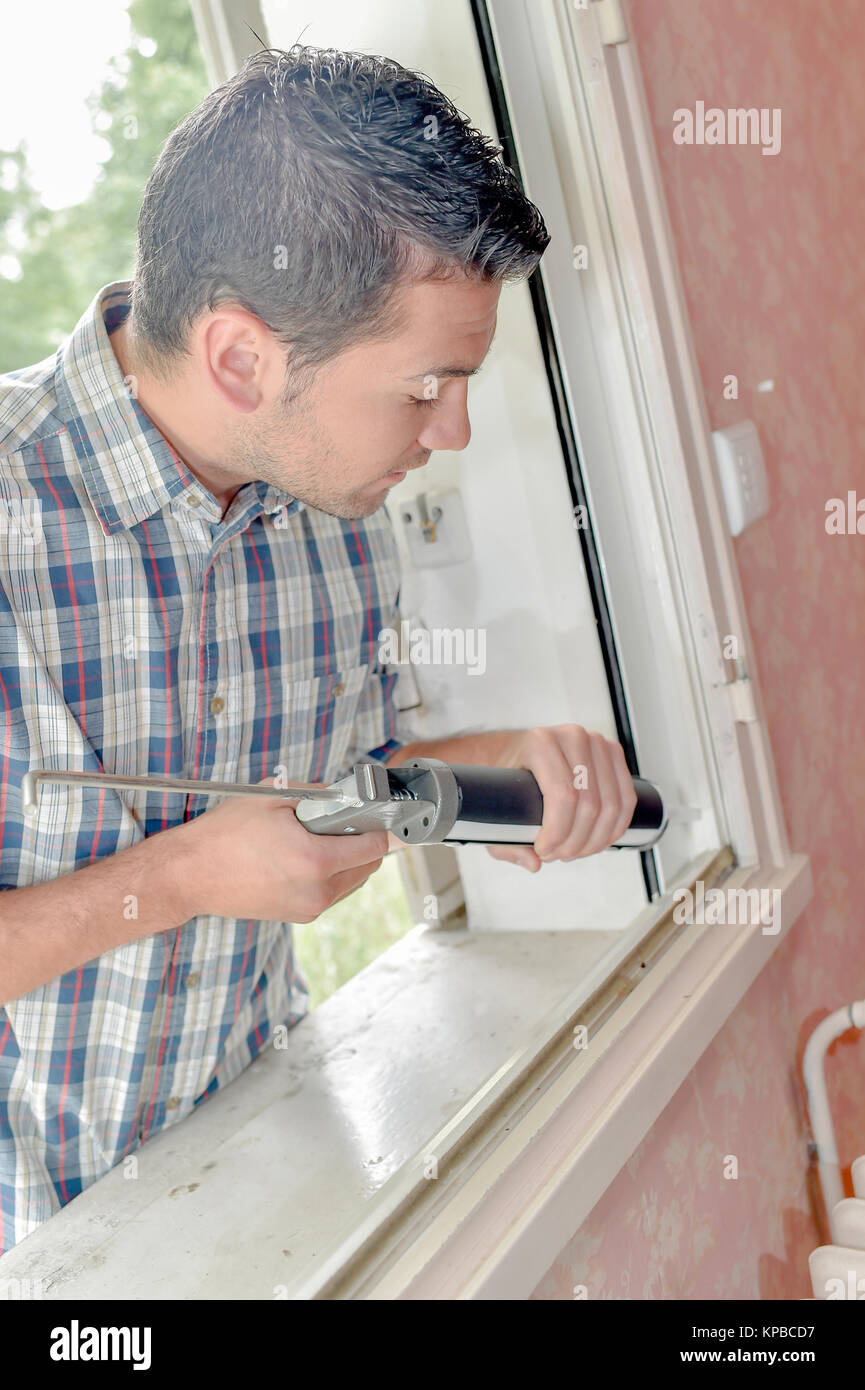 handy man putting in window Stock Photo - Alamy