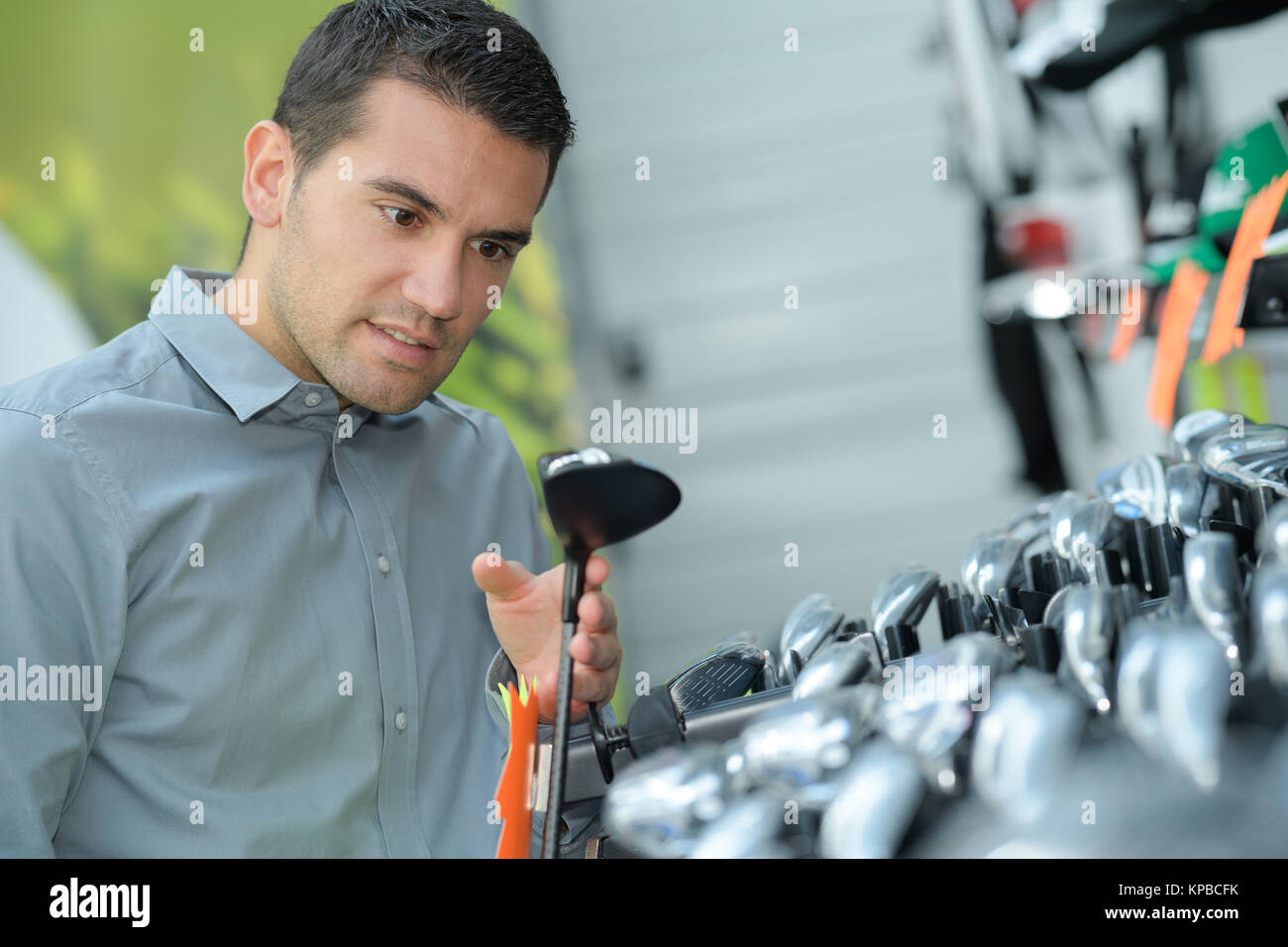 man inspecting golf materials Stock Photo - Alamy