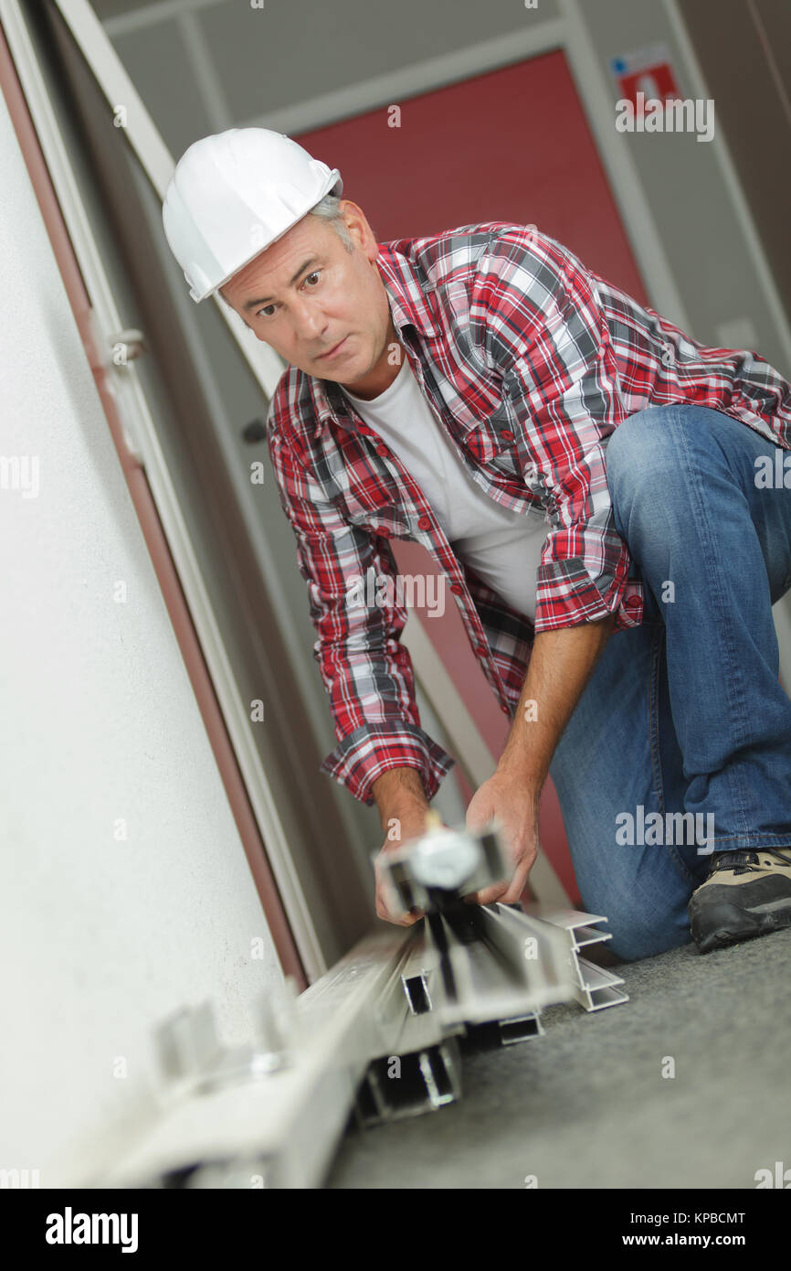 worker putting down aluminum frames Stock Photo - Alamy