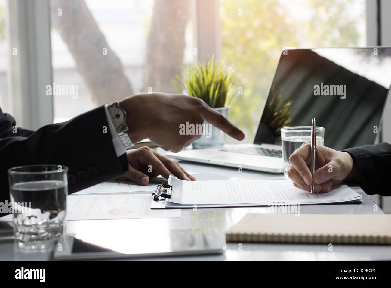 Businessman signing contract paper with partner, reach agreement and ...