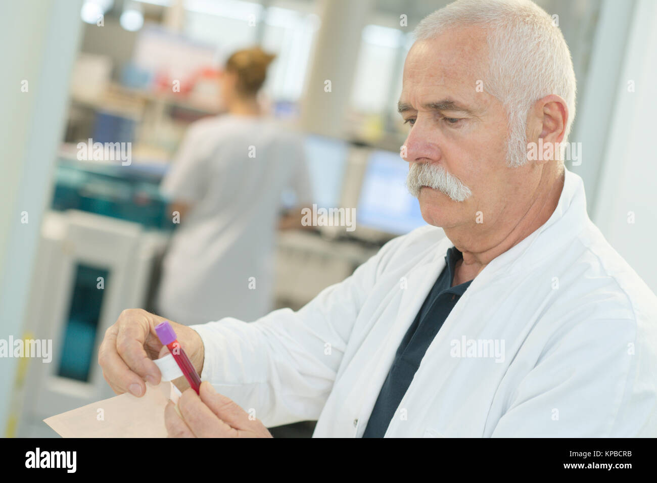 Elderly male biologist professor examining hi-res stock photography and ...