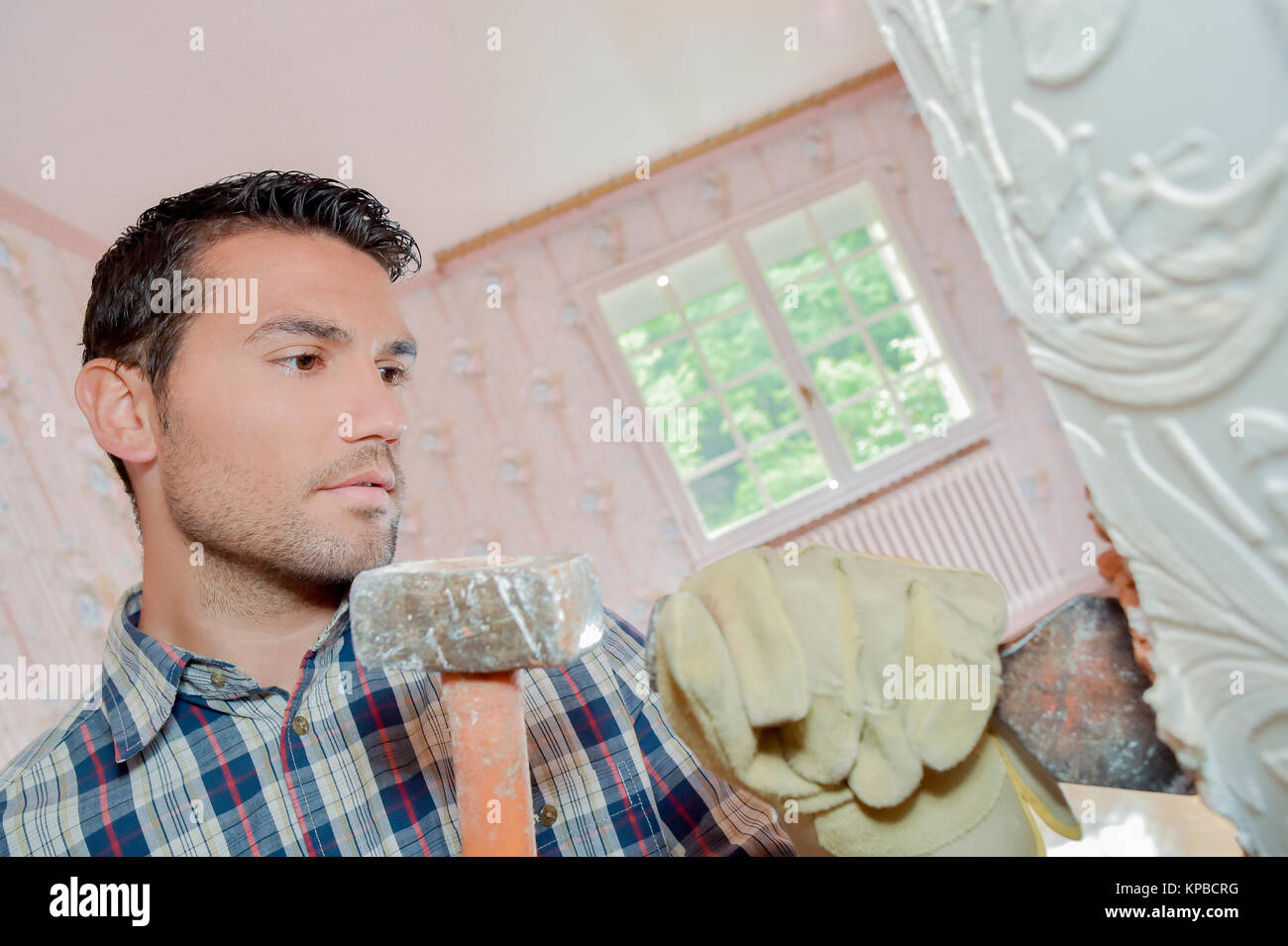 Chiselling at a wall Stock Photo - Alamy
