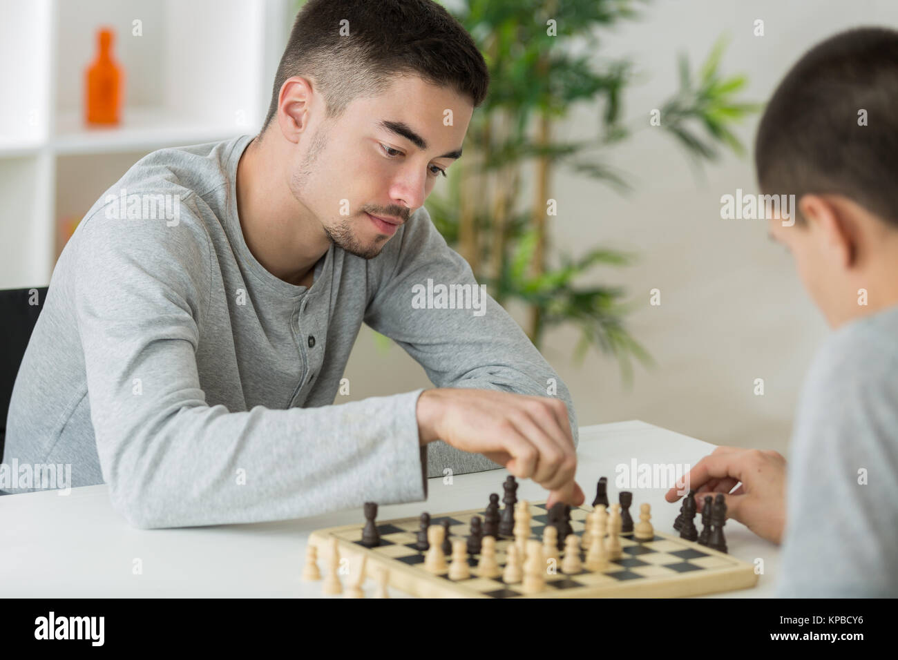 two young man playing chess Stock Photo - Alamy