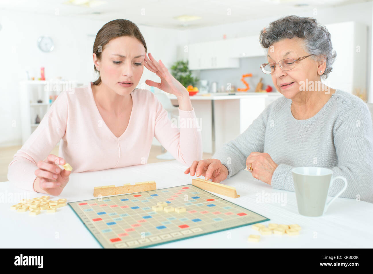 old lady in geriatric hospice playing with assistant Stock Photo - Alamy