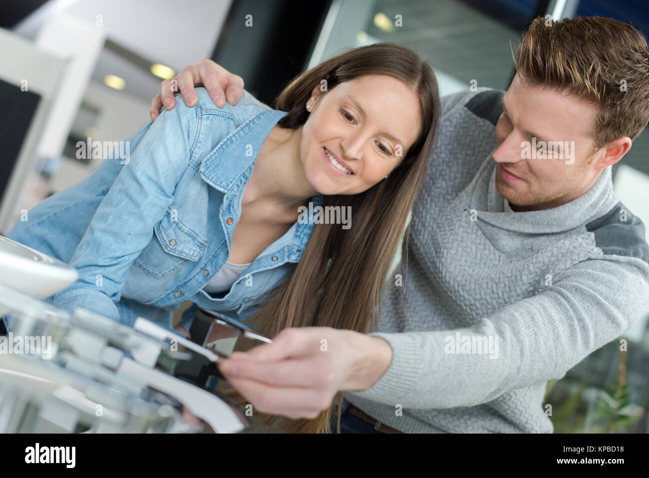 young couple holding credit card together Stock Photo - Alamy