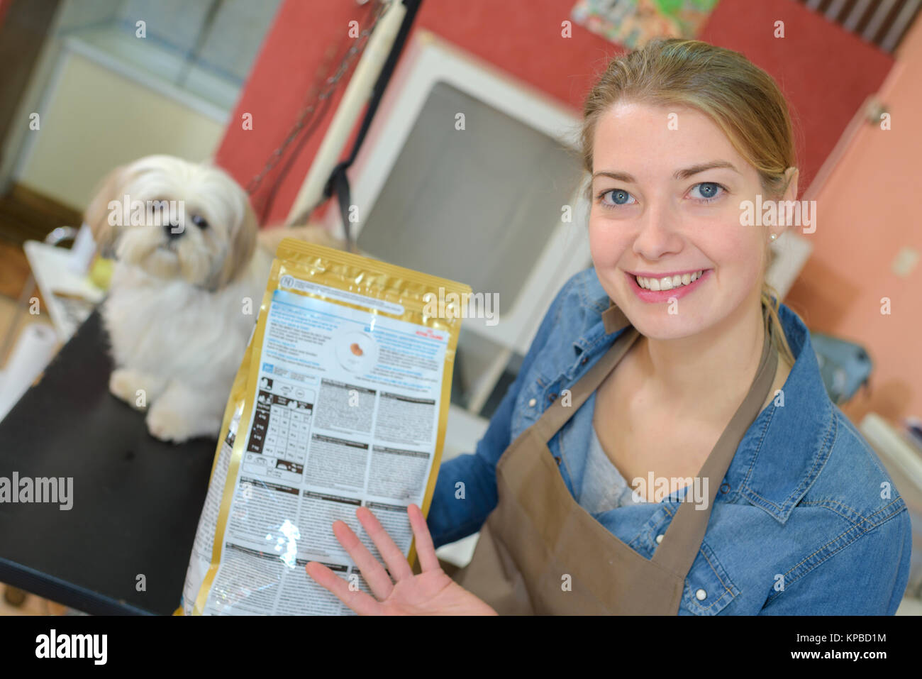 Woman showing packet of dog food Stock Photo - Alamy