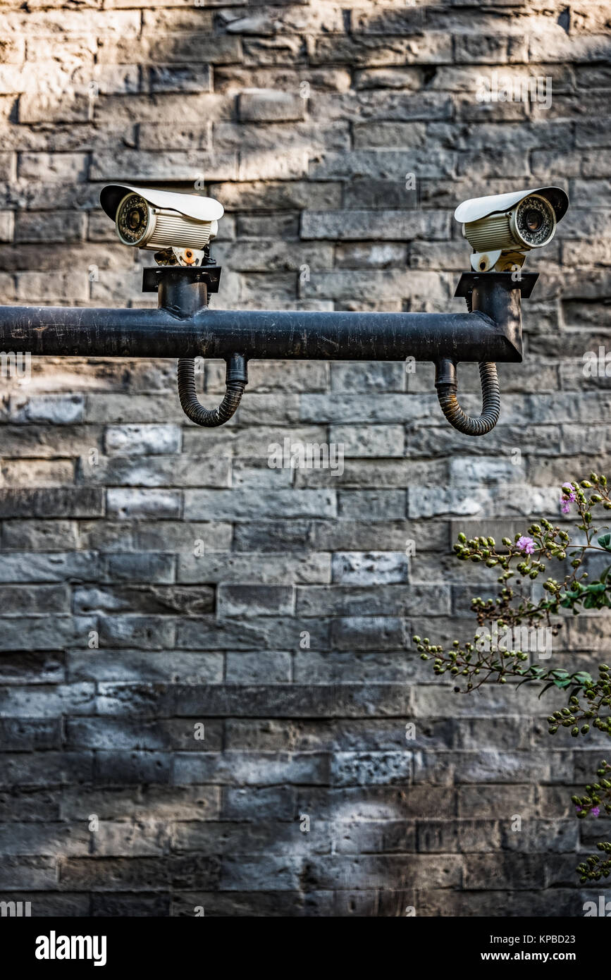 CCTV security camera front of a brick wall in city of China Stock Photo ...