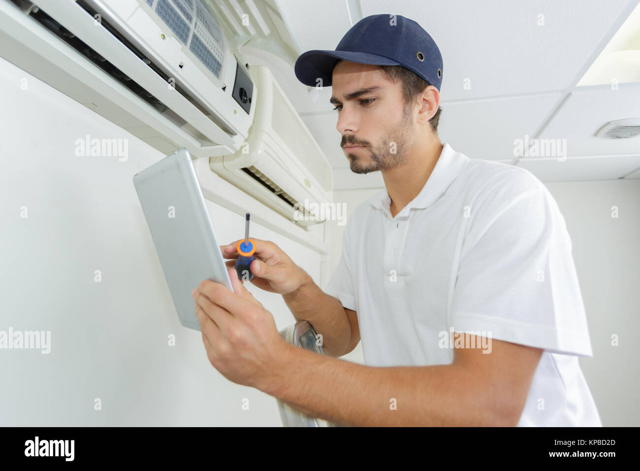 young contractor working carefully and seriously at clients office ...