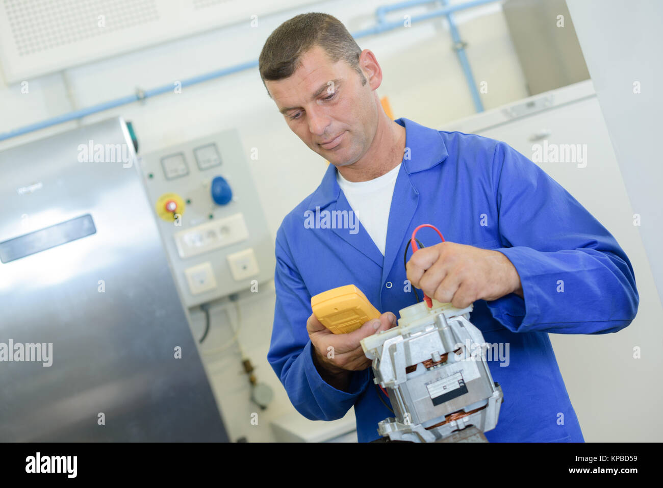 Electrician testing electrical component Stock Photo - Alamy