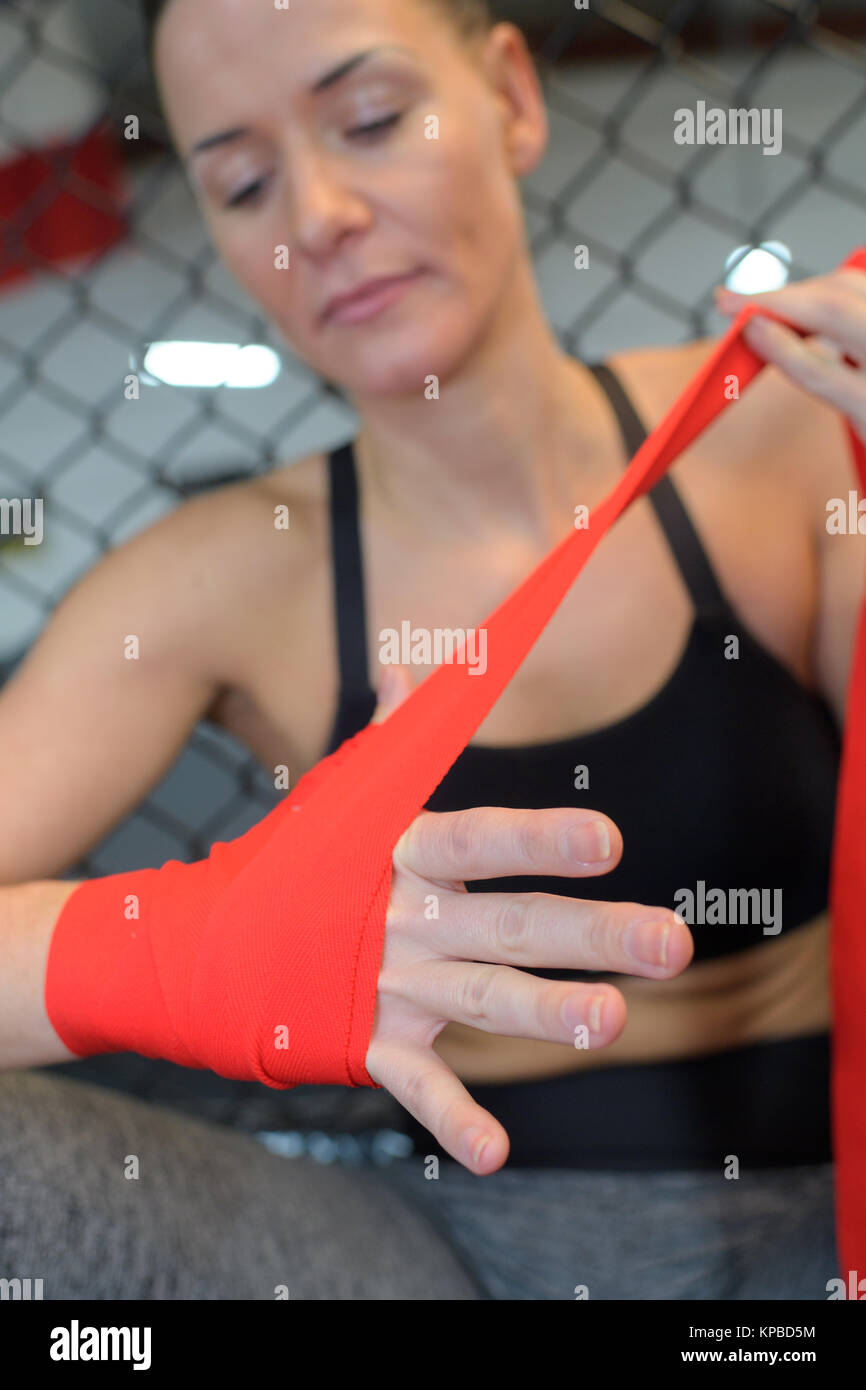 woman is wrapping hands with red boxing hand wraps Stock Photo - Alamy