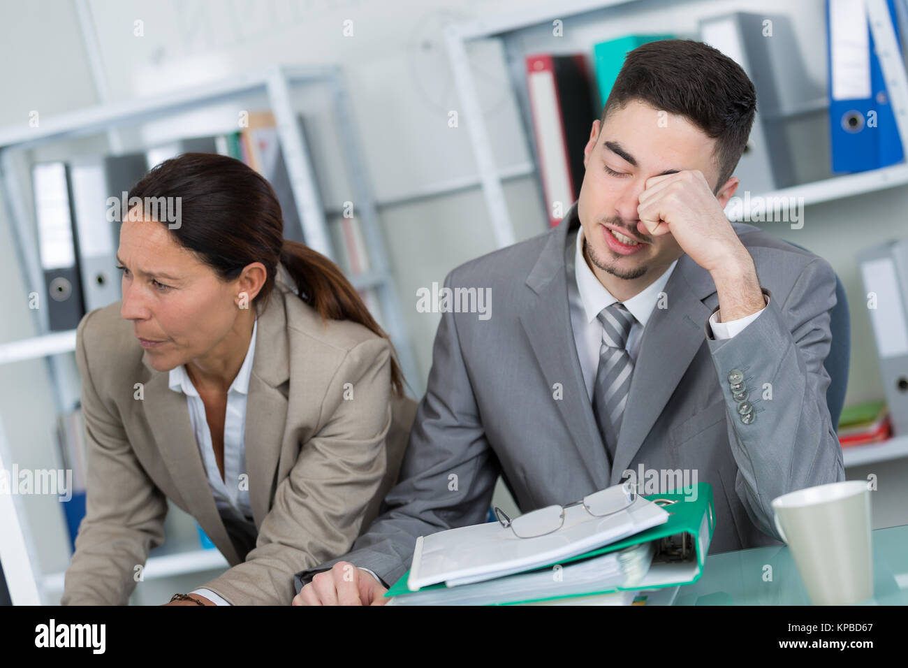 businessman tired solving problem in office with his co-worker Stock ...