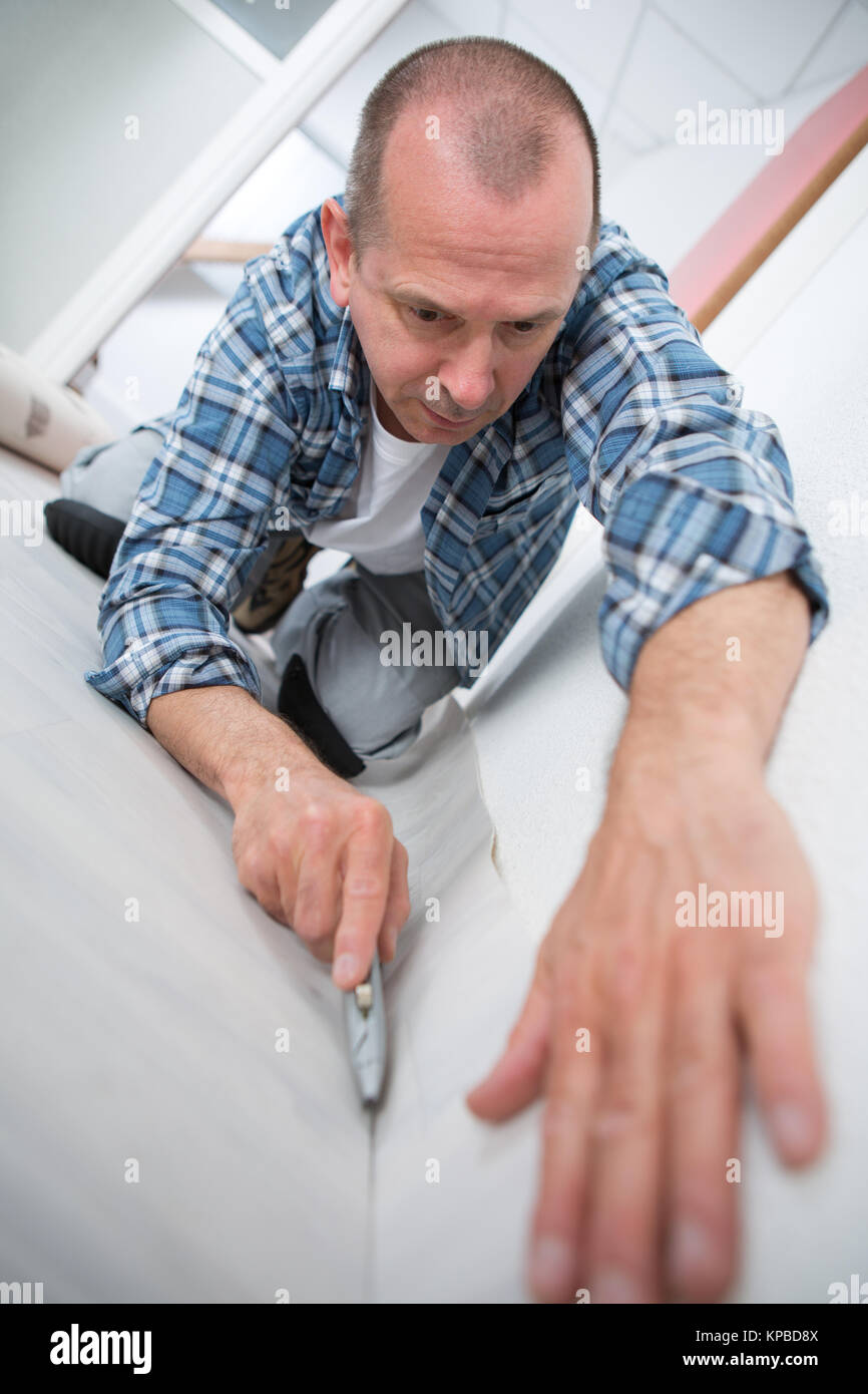 craftsman fitting a carpet Stock Photo - Alamy