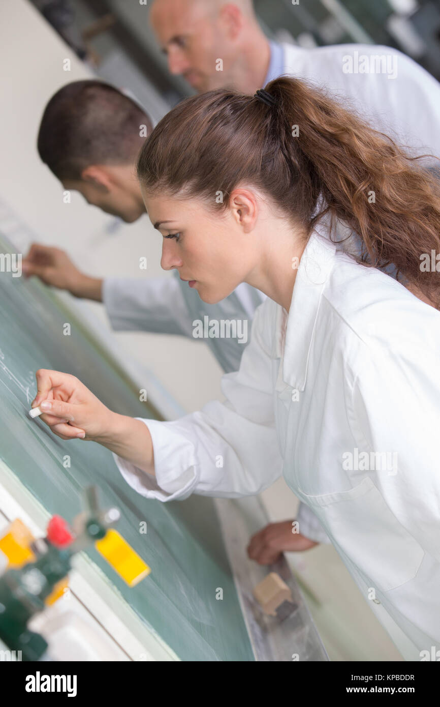 students writing on the board Stock Photo - Alamy