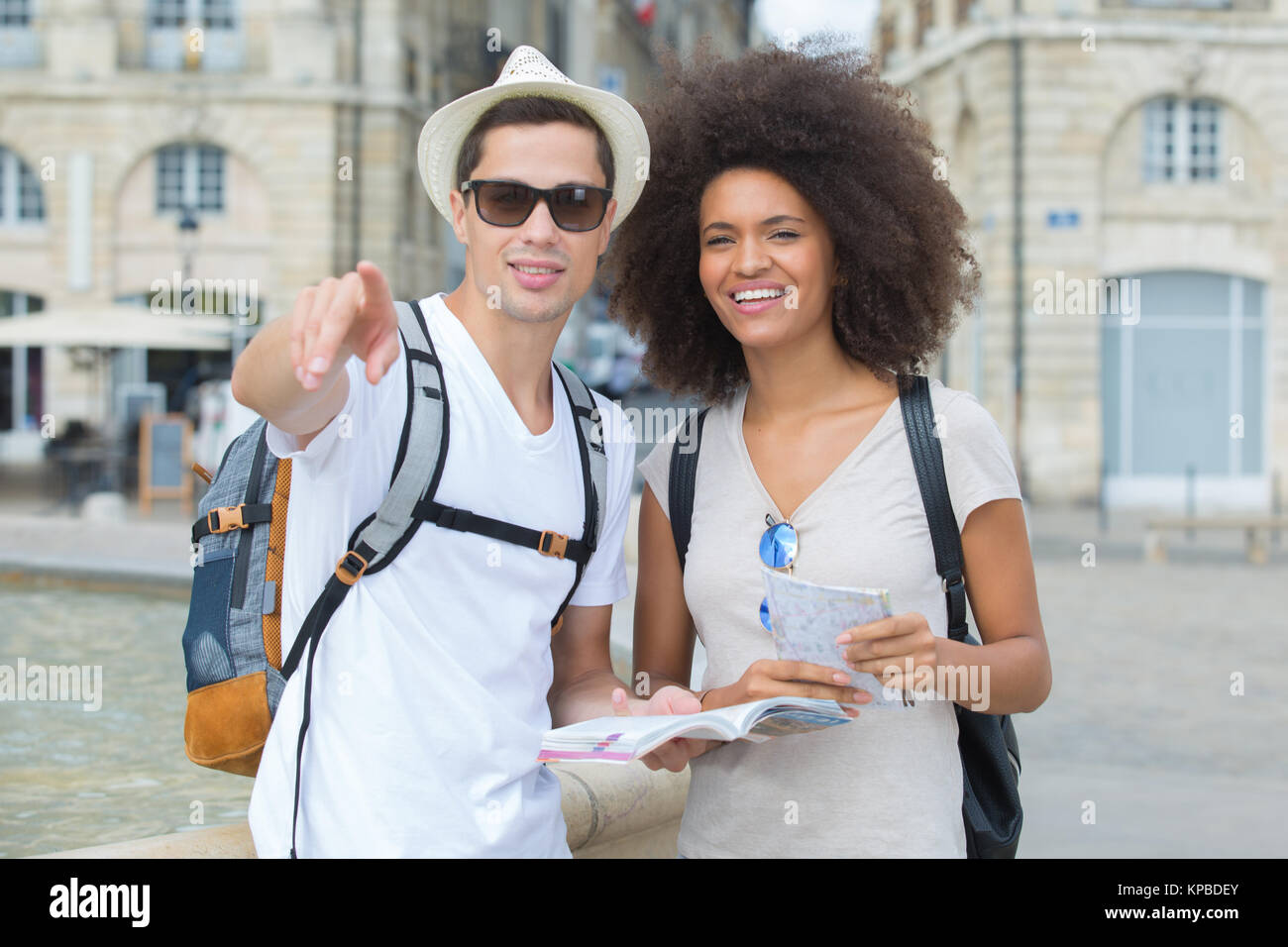 happy tourists sightseeing city with map Stock Photo - Alamy