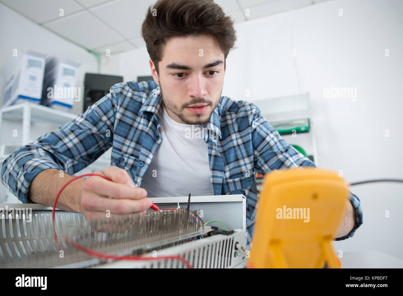 Technician using multimeter Stock Photo - Alamy