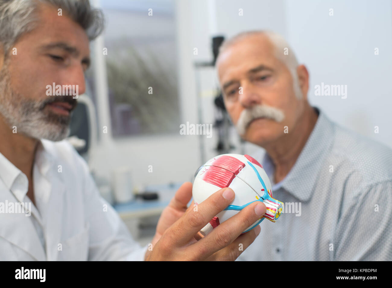 ophthalmologist with eye model Stock Photo - Alamy