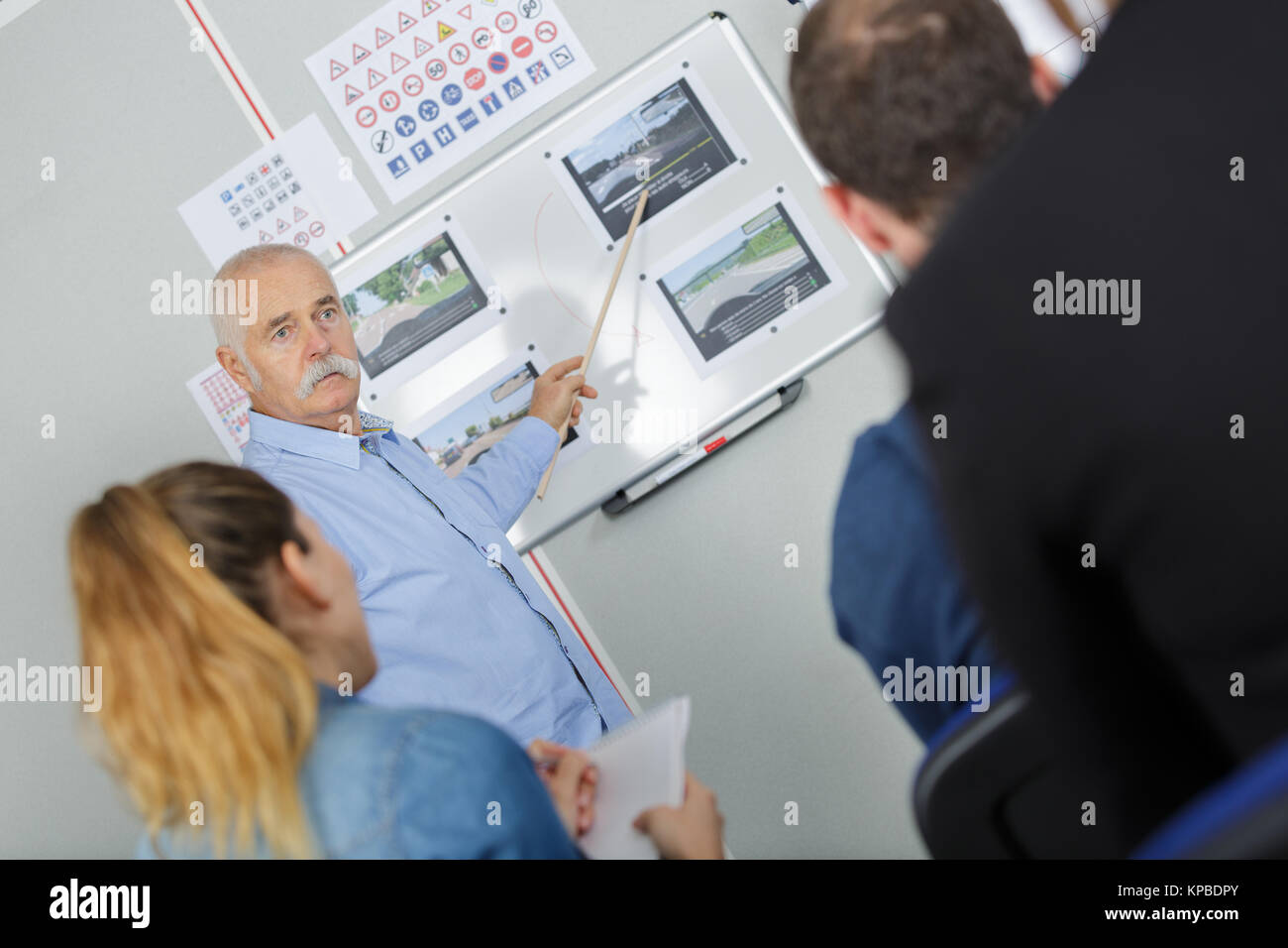 driving school - driving instructor in his class Stock Photo - Alamy